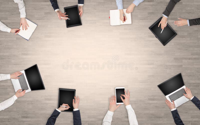 Group of People with Devices in Hands Having Desk Discussion and ...