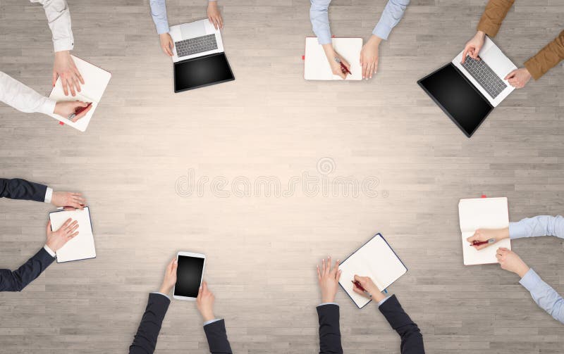 Group of People with Devices in Hands Having Desk Discussion and ...