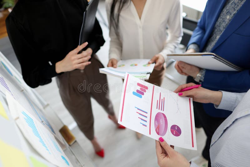 Group of People with Documents in Hands Standing Near Blackboard at ...