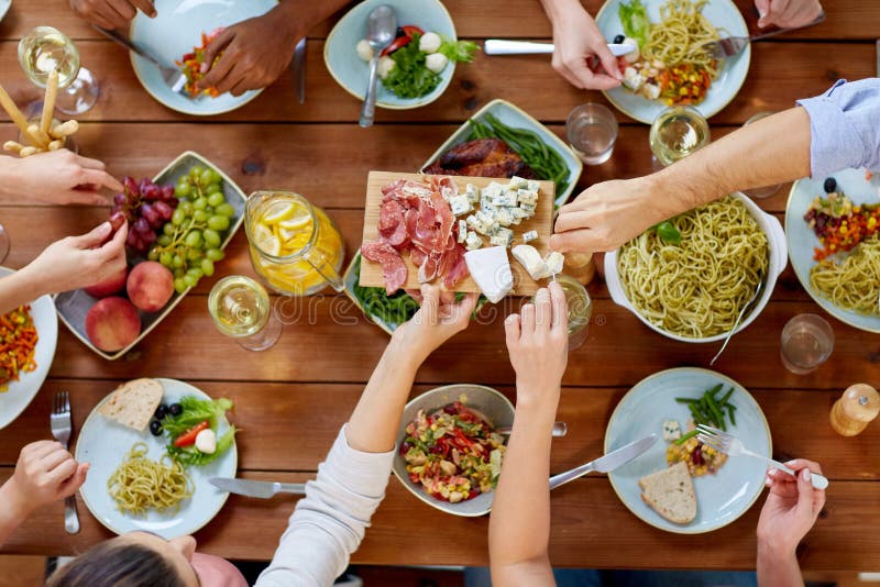 Group of People Eating at Table with Food Stock Image - Image of ...