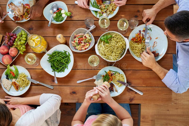 Group of People Eating at Table with Food Stock Photo - Image of ...