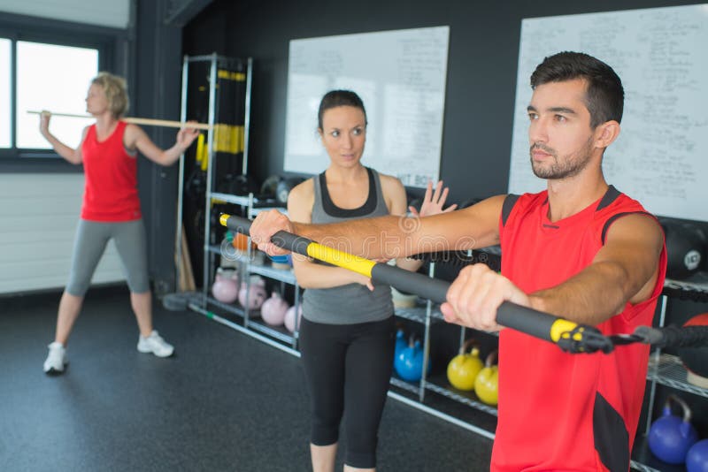 Group People Excercising with Bars in Gym Stock Image - Image of ...