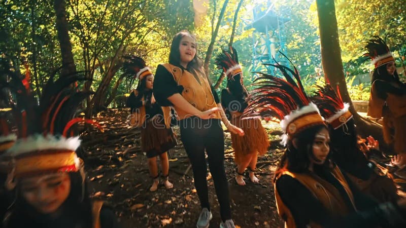 Group of People in a Forest with Sunlight Filtering through the Trees ...