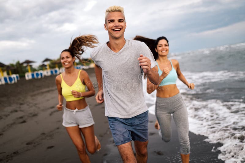 Group of People, Friends Running on the Beach at Sunset Stock Image ...
