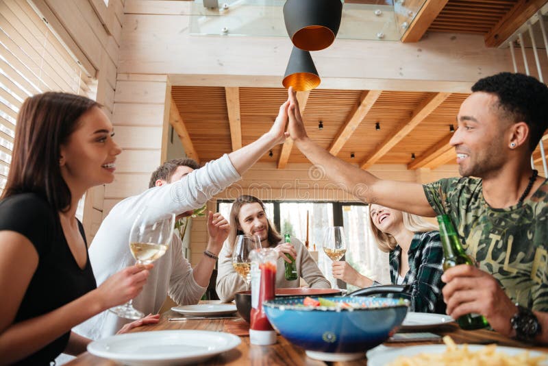 Group of People Having Dinner and Giving High Five Stock Photo - Image ...