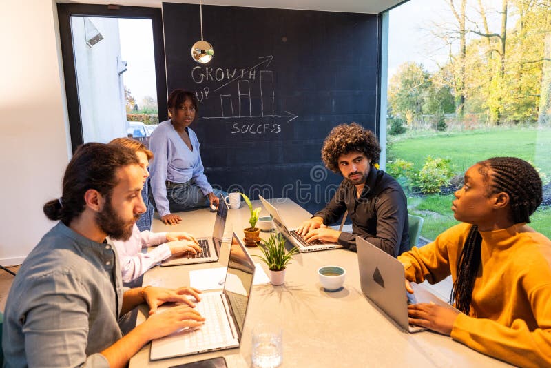 A Group of People is Having a Meeting at a Table with Laptops Stock ...