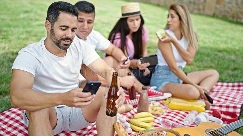 Group of People Having Picnic Using Smartphones and Touchpad at Park ...