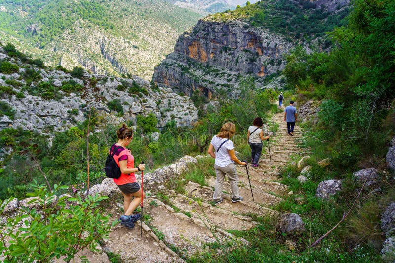 Group of People Hiking on the Mountain Path Going Down Step Stock Photo ...