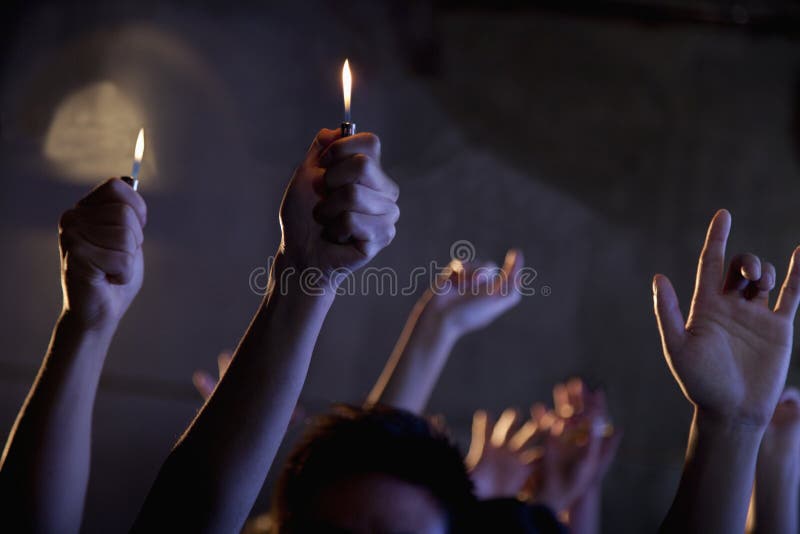 Group of People Holding Cigarette Lighters at a Concert Stock Photo ...