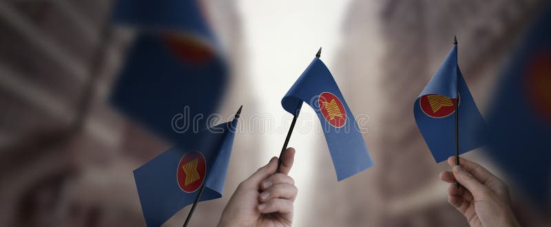 A Group of People Holding Small Flags of the ASEAN in Their Hands Stock ...