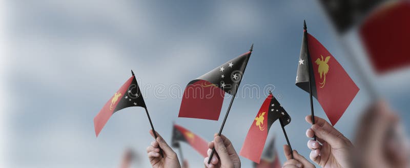 A Group of People Holding Small Flags of the Papua New Guinea in Their ...