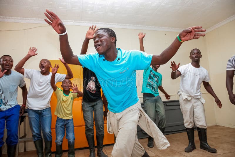 Group of People Joyously Dancing in a Circle, with Their Hands Raised ...