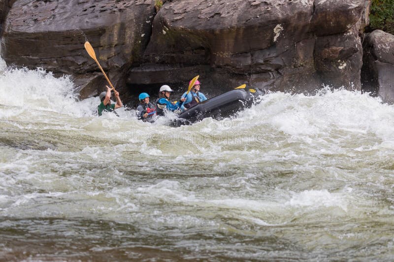 Group of People in a Kayak Navigating through the Choppy Waters of a ...