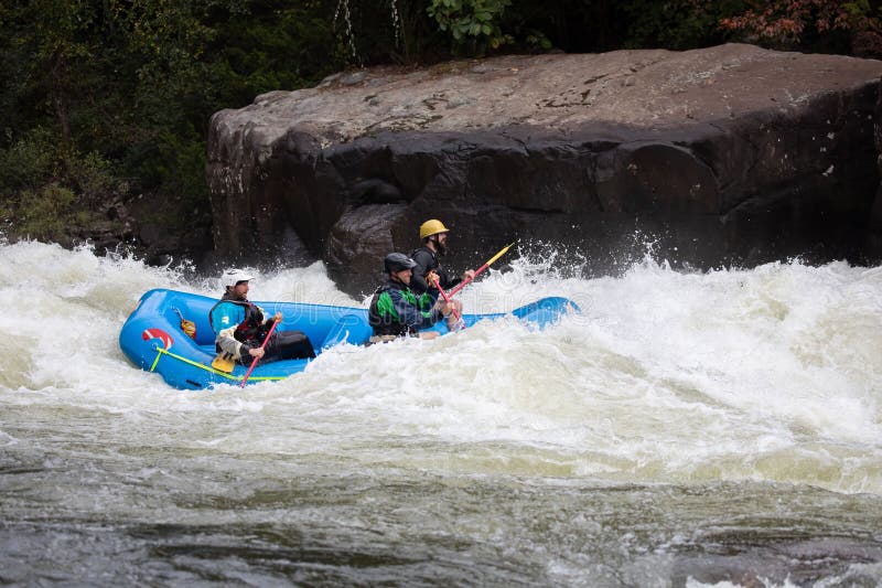 Group of People in a Kayak Navigating through the Choppy Waters of a ...