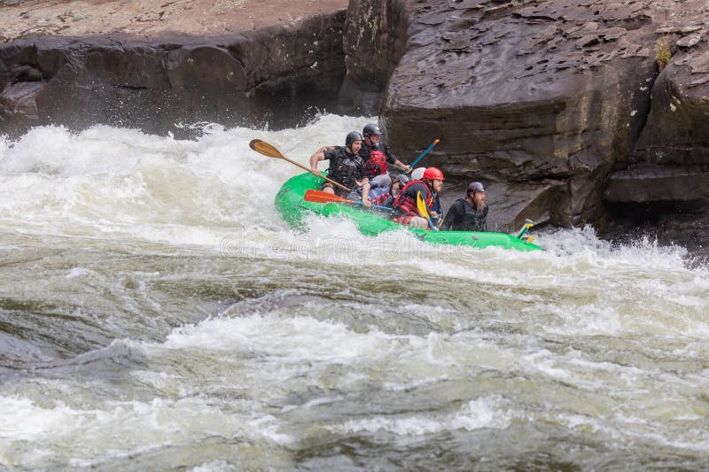 Group of People in a Kayak Navigating through the Choppy Waters of a ...