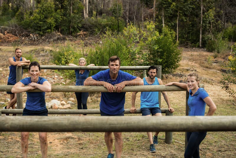 Group of People Leaning on Hurdles during Obstacle Training Stock Photo ...