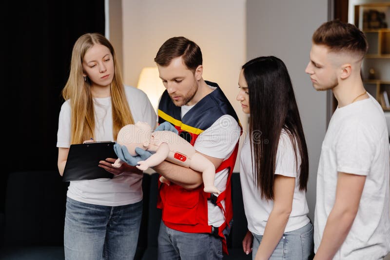 Group of People Learning How To Make First Aid with Dummy Child during ...