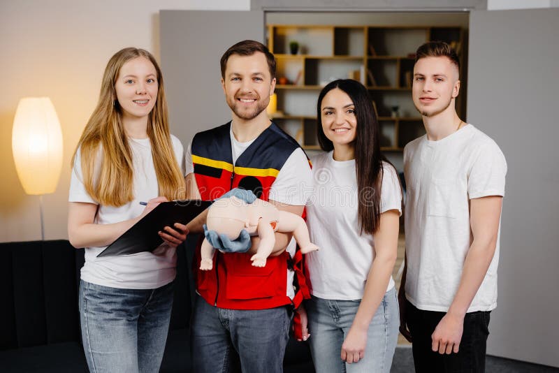 Group of People Learning How To Make First Aid with Dummy Child during ...