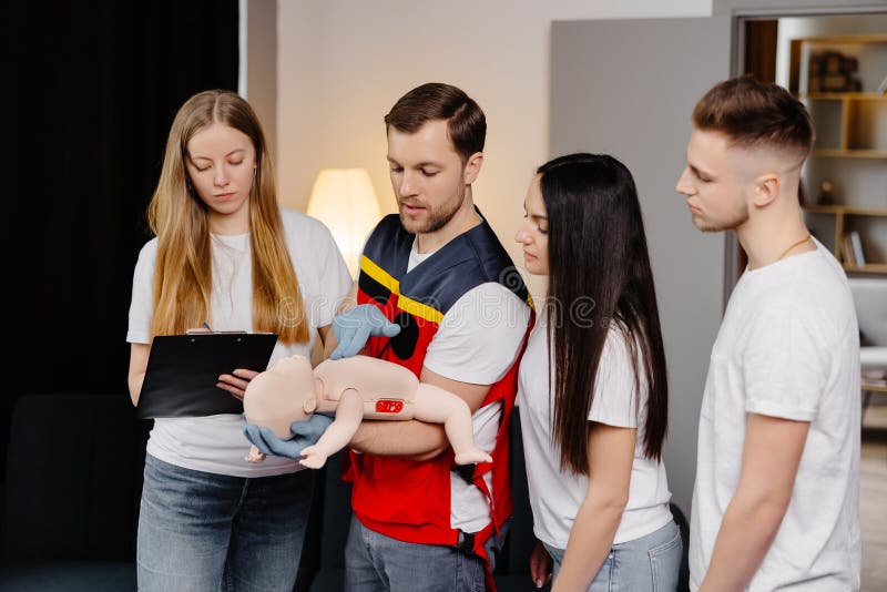 Group of People Learning How To Make First Aid with Dummy Child during ...