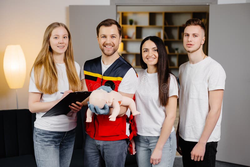 Group of People Learning How To Make First Aid with Dummy Child during ...