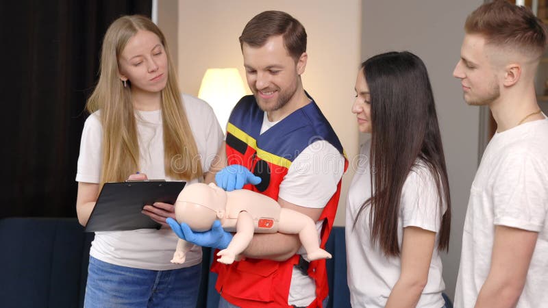 Group of People Learning How To Make First Aid with Dummy Child during ...