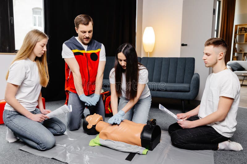 Group of People Learning How To Make First Aid Heart Compressions with ...