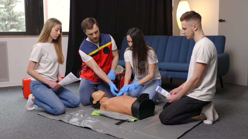Group of People Learning How To Make First Aid Heart Compressions with ...