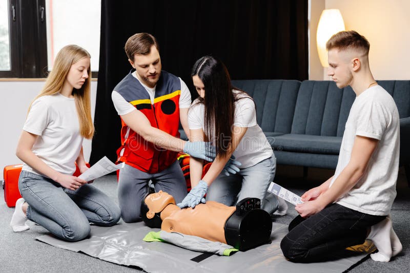 Group of People Learning How To Make First Aid Heart Compressions with ...