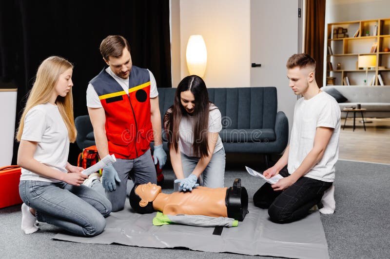 Group of People Learning How To Make First Aid Heart Compressions with ...