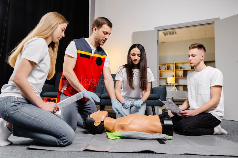 Group of People Learning How To Make First Aid Heart Compressions with ...