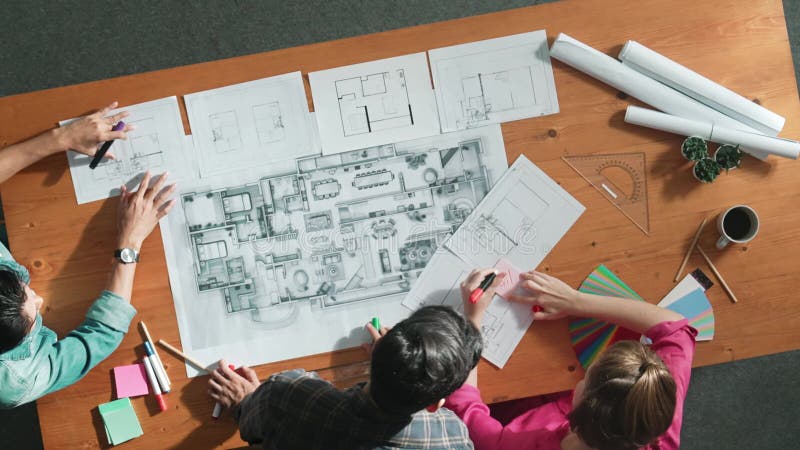 Group of Diverse Team Looking at Blueprint while Brainstorming Idea ...