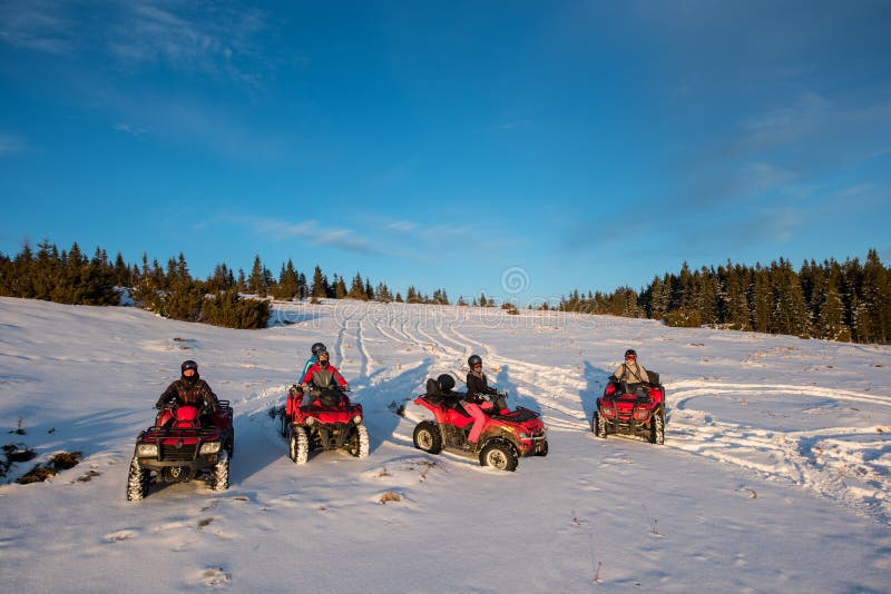 Group of People on Off-road Quad Bikes in the the Mountains in Winter ...