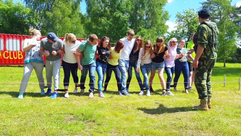 A Group of People Overcome an Obstacle Course with an Instructor. Minsk ...