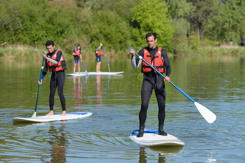 Group People on Paddle Boards on Lake Stock Photo - Image of leisure ...