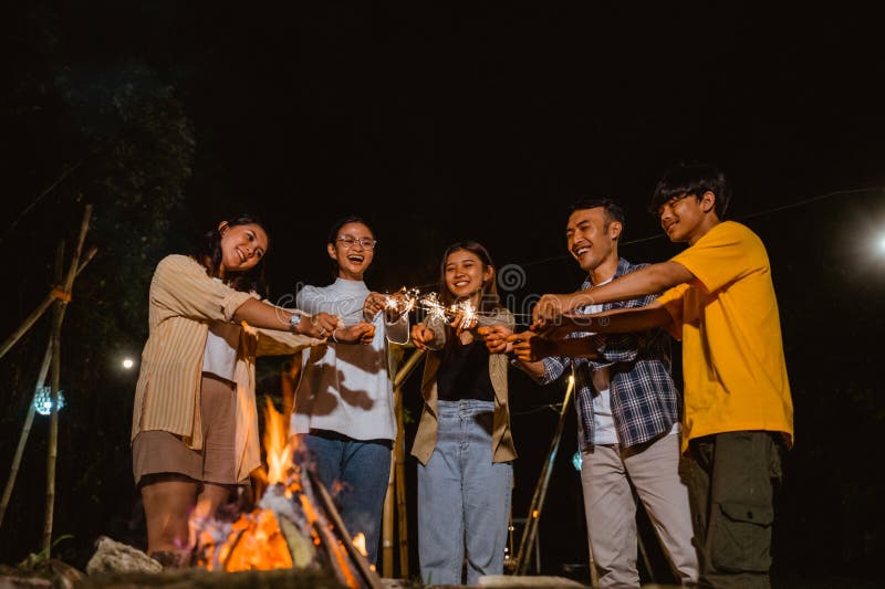A Group of People Playing Fireworks Happily and Put Its Together Stock ...