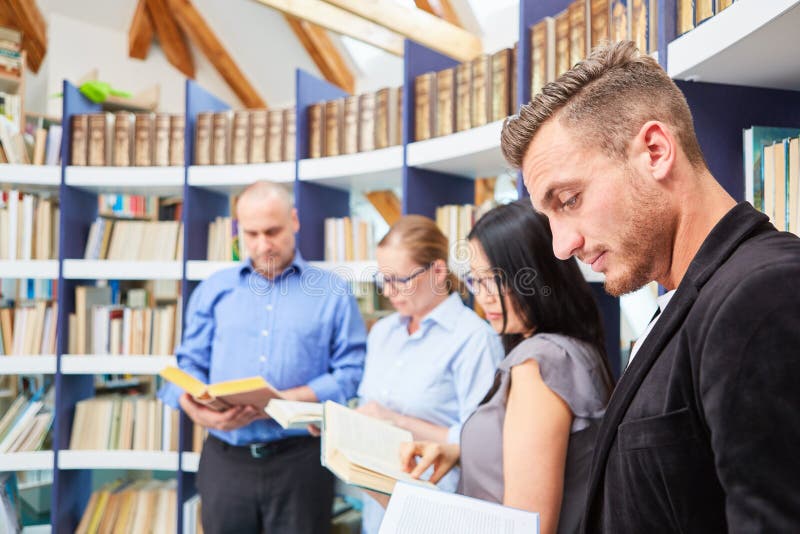 Group of People while Reading Book in the Library Stock Photo - Image ...