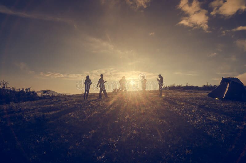 Group of People Relaxing on Field with Sunset Concept Stock Image ...