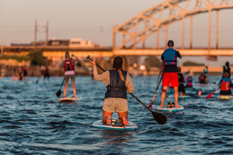 Group of People Rowing with SUP Paddle Boards Along the River Stock ...