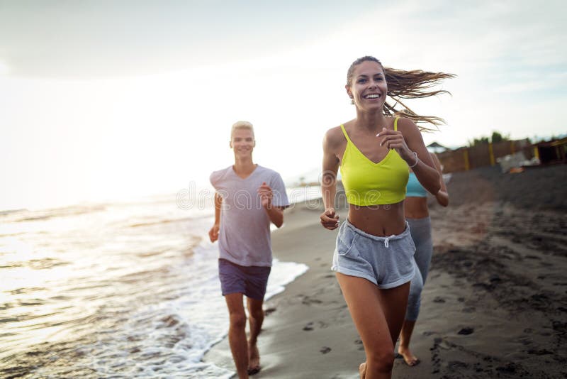 Group of People, Friends Running on the Beach at Sunset Stock Image ...