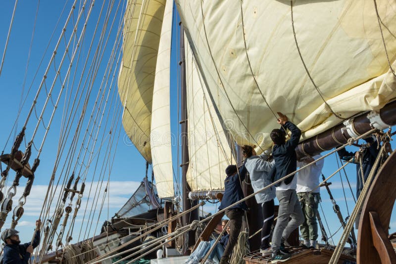 Group of People on a Sailing Ship on Blue Cloudy Sky Background ...