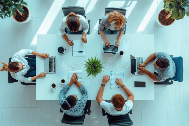 A Group of People are Sitting Around a Table in a Conference Room Stock ...