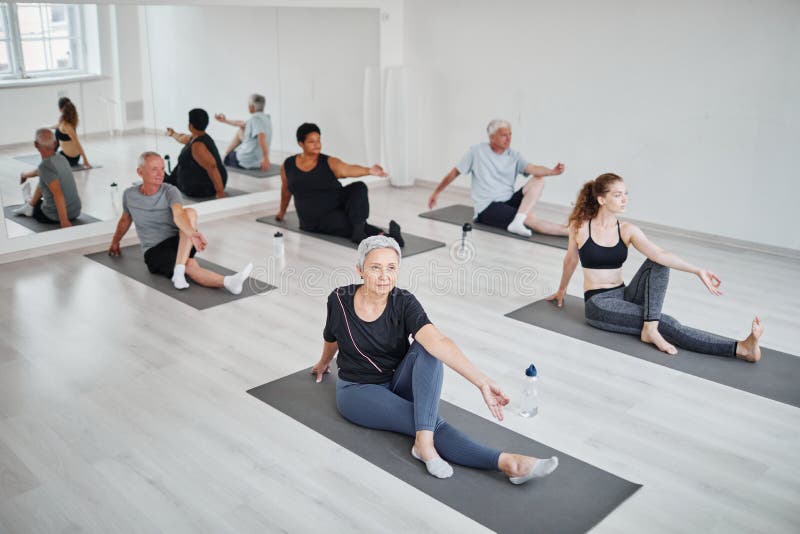 People doing yoga in class stock image. Image of wellbeing - 232980201