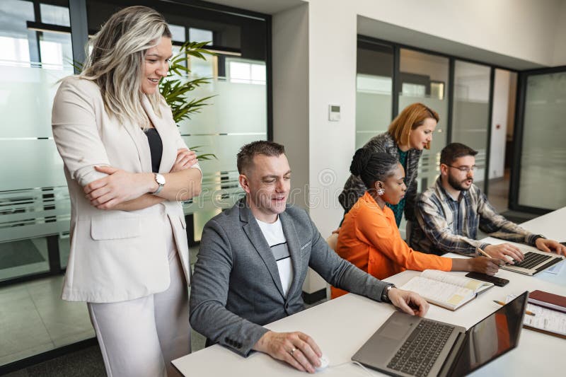 Group of People Sitting at Table with Laptops Stock Image - Image of ...