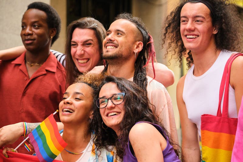 A Group of People are Smiling and Holding Rainbow Flags. Stock Photo ...