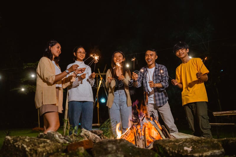 A Group of People Smiling while Playing the Fireworks Stock Image ...