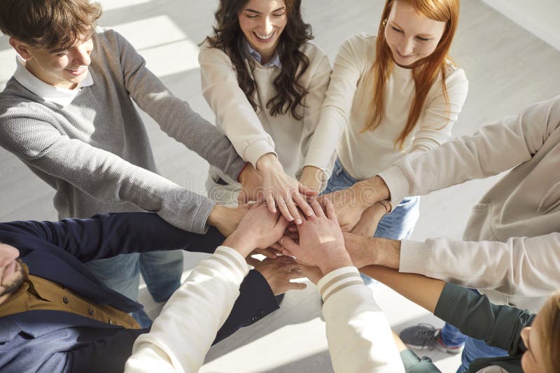 Group of People Stacking Hands, Involved in Teambuilding Activity ...