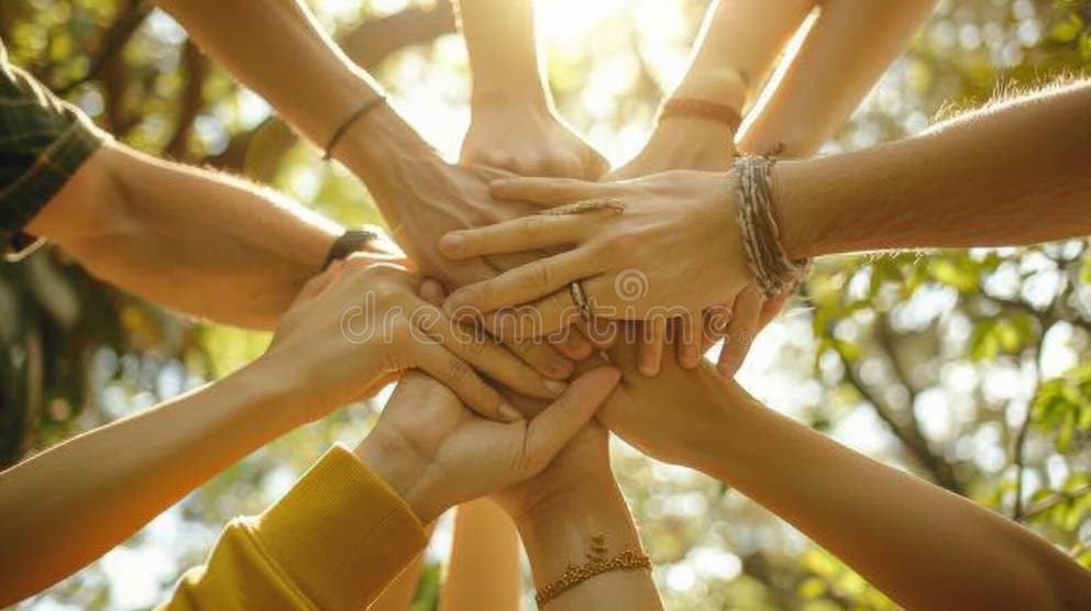 Group of People Stacking Their Hands Together in a Gesture of Unity and ...