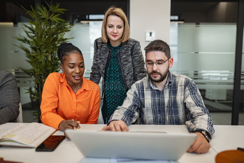 Group of People Standing Around a Laptop Computer Stock Image - Image ...