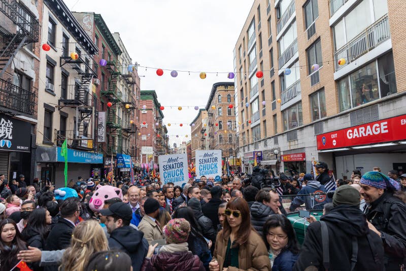 Group of People Standing on a Busy Street with a Multitude of Flags and ...