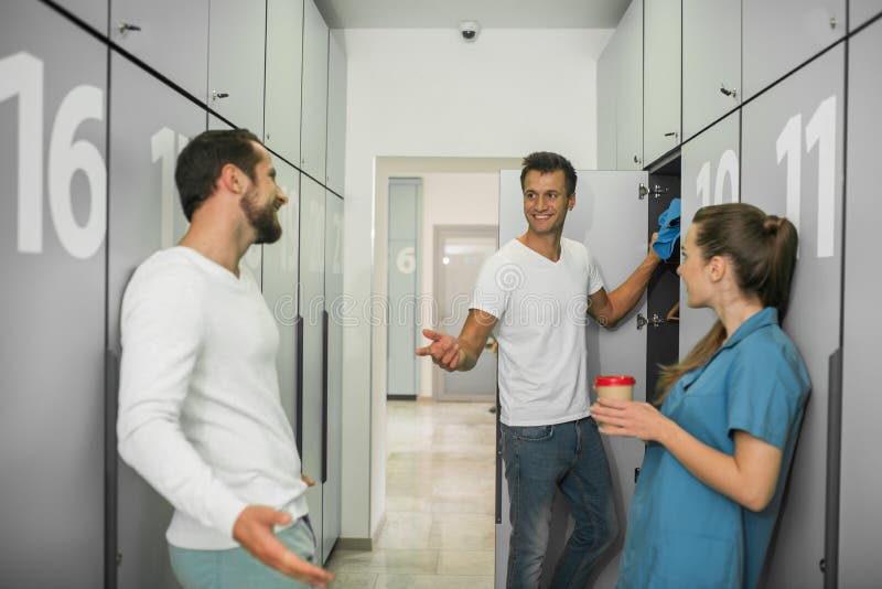 Group of People Standing in the Changing Room and Talking Stock Image ...